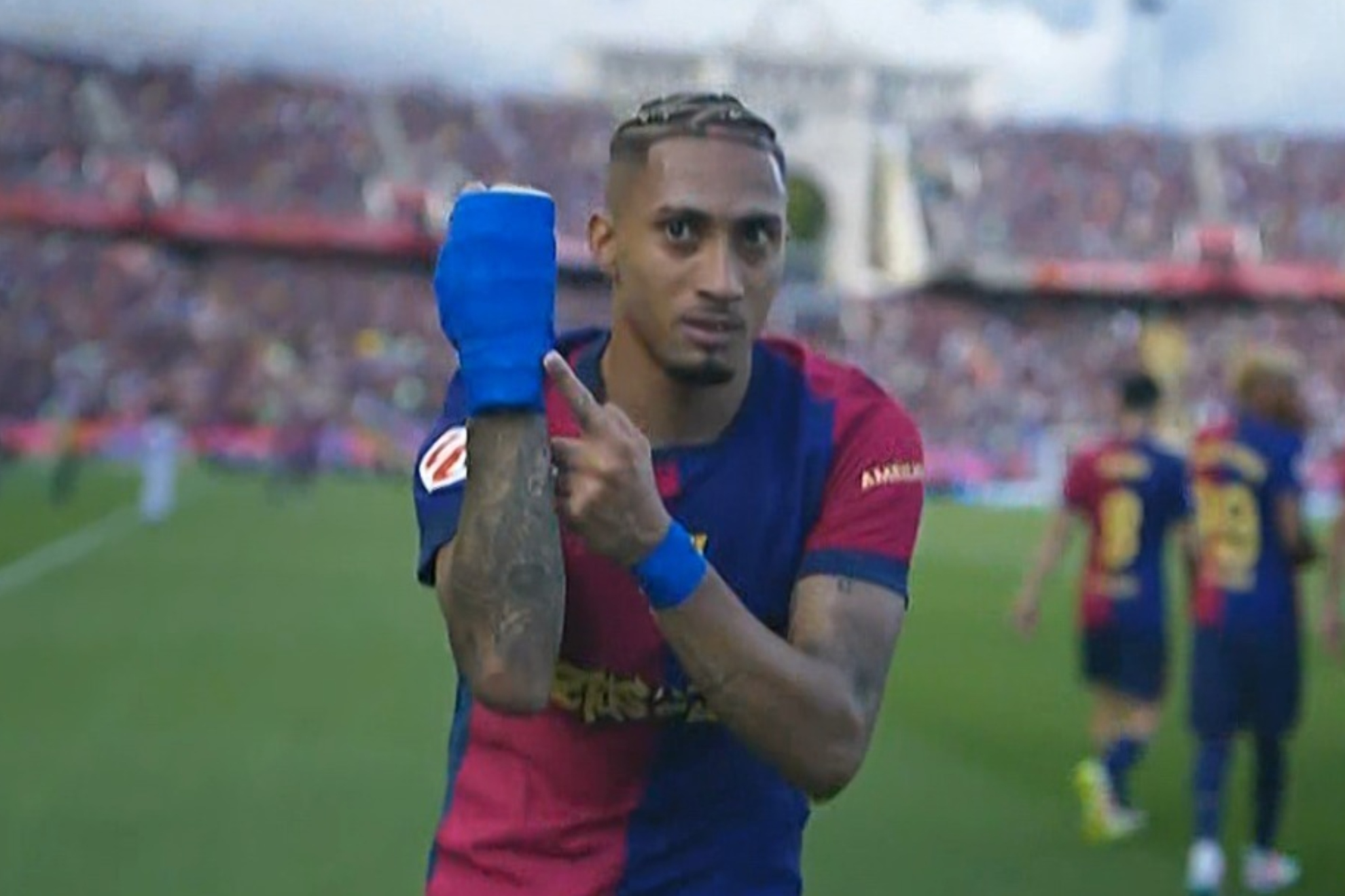 La celebración de Raphinha... señalándose la venda